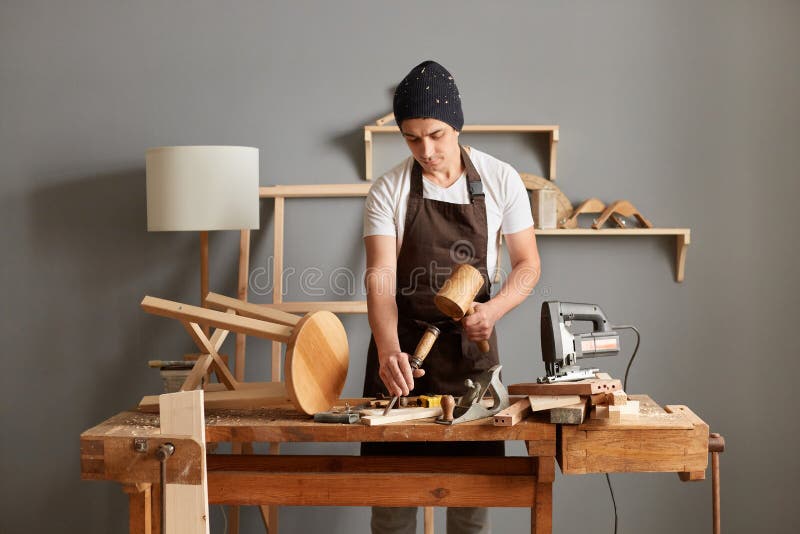Portrait of Man Carpenter Wearing Brown Apron and Black Cap Using ...