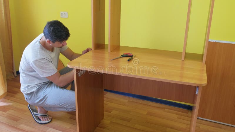 Portrait Of Man Collecting Parts Of Computer Table Screwing Shelf Screwdriver Stock Footage