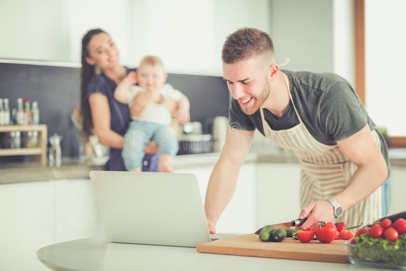 Portrait of Man Cooking Vegetable in the Kitchen while Looking at a ...