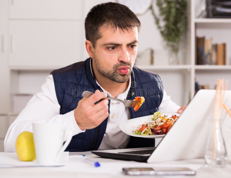 Portrait of Man Eating Vegetable Salad at Table with Laptop Stock Image ...