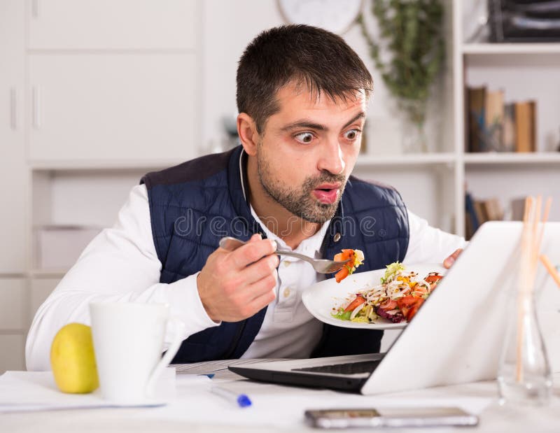 Portrait of Man Eating Vegetable Salad at Table with Laptop Stock Image ...