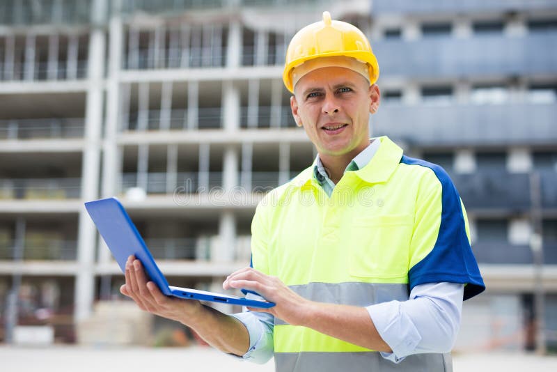 Portrait of a Man Engineer Monitoring the Progress of Work on a Laptop ...