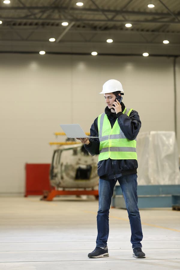 Portrait of a Man , Factory Engineer in Work Clothes Holding Laptop and ...