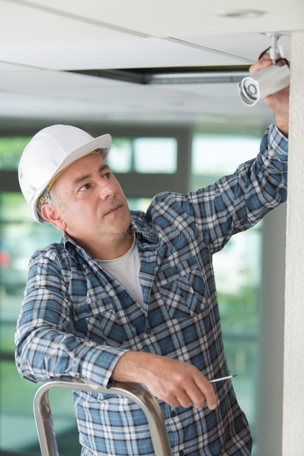 Portrait man fitting cctv stock image. Image of skill - 196546927