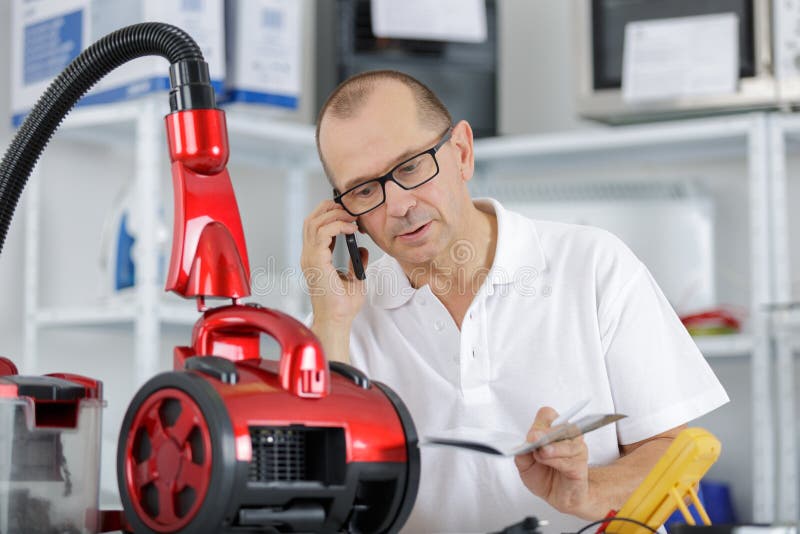 Portrait man fixing hoover stock photo. Image of adult - 270839690