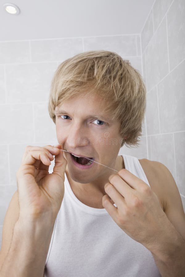 Portrait of Man Flossing Teeth in Bathroom Stock Image - Image of ...