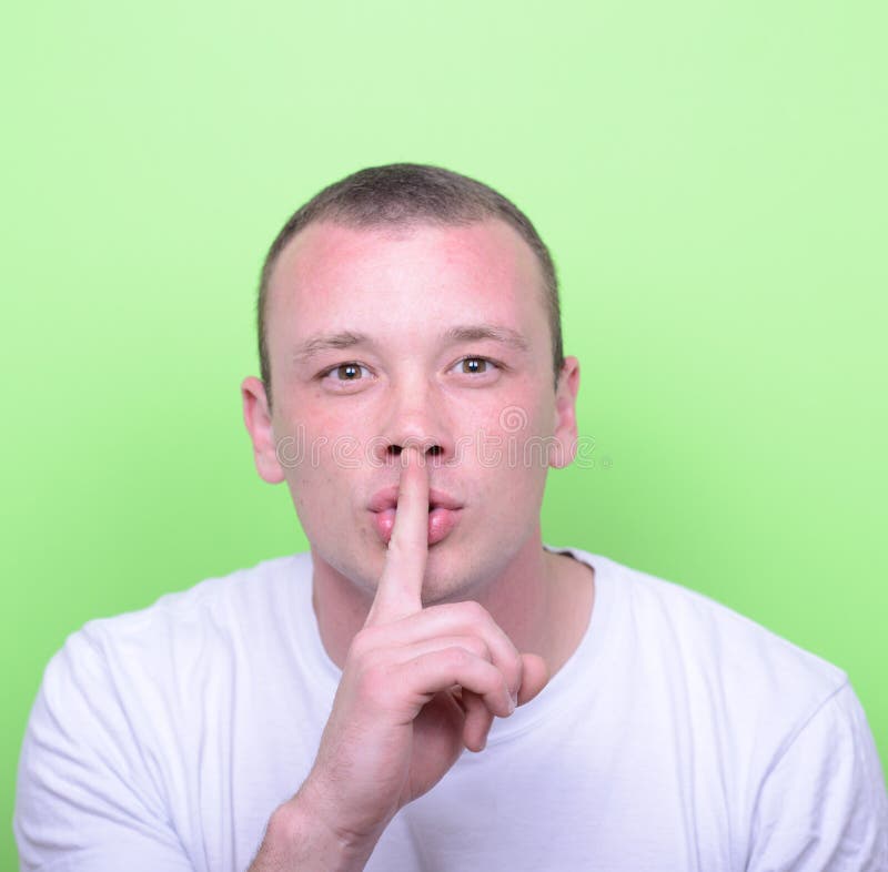 Portrait of Man with Gesture for Silence Against Green Background Stock ...