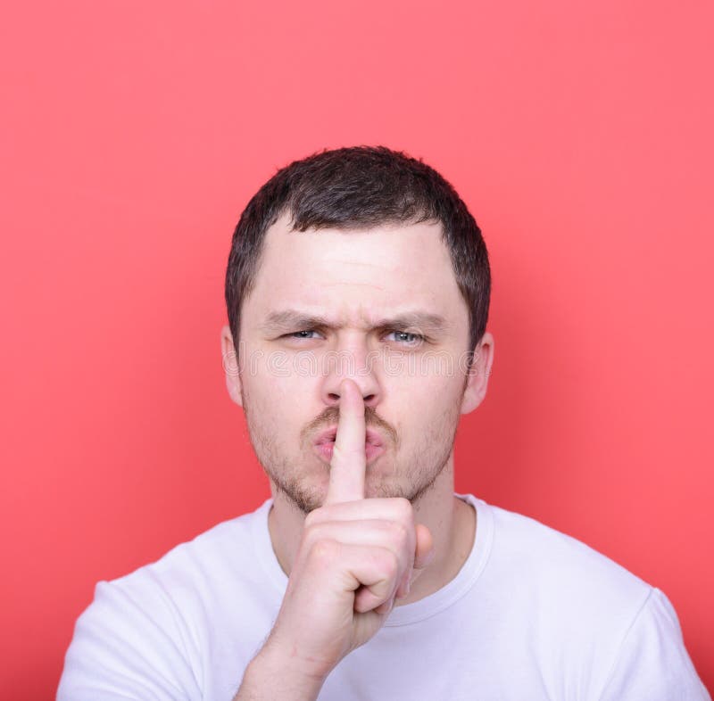 Portrait of Man with Gesture for Silence Against Red Background Stock ...