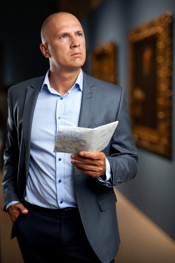 Portrait of Man with a Guide Looking at Pictures at Museum Stock Image ...