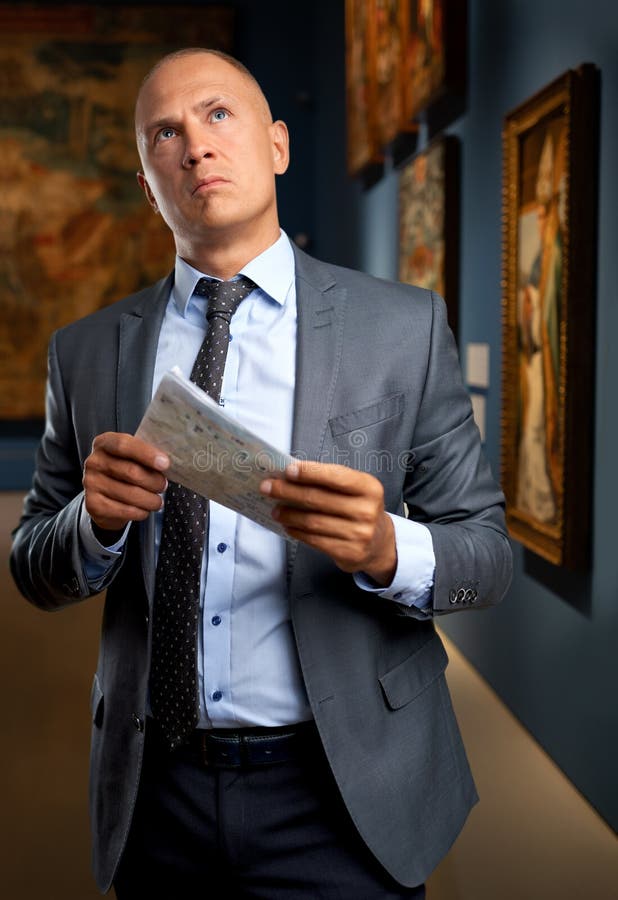 Portrait of Man with a Guide Looking at Pictures at Museum Stock Photo ...