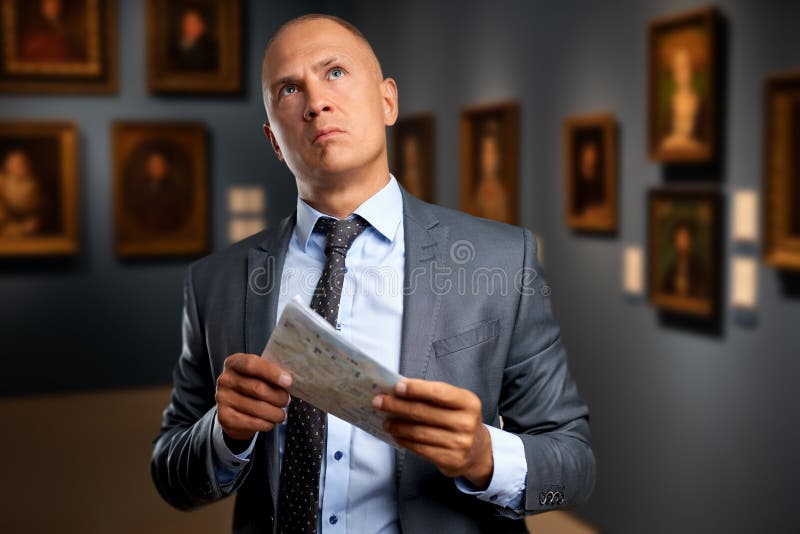 Portrait of Man with a Guide Looking at Pictures at Museum Stock Photo ...