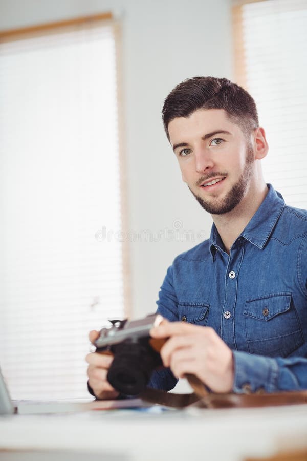 Portrait of Man Holding Camera Stock Image - Image of focused, cool ...
