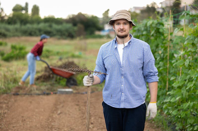 Portrait of Man Holding a Rake in Farmer Field Stock Photo - Image of ...
