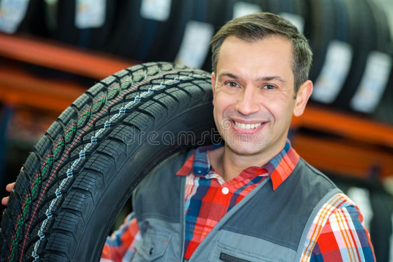 Portrait Man Holding Tyre Over Shoulder Stock Image - Image of mechanic ...