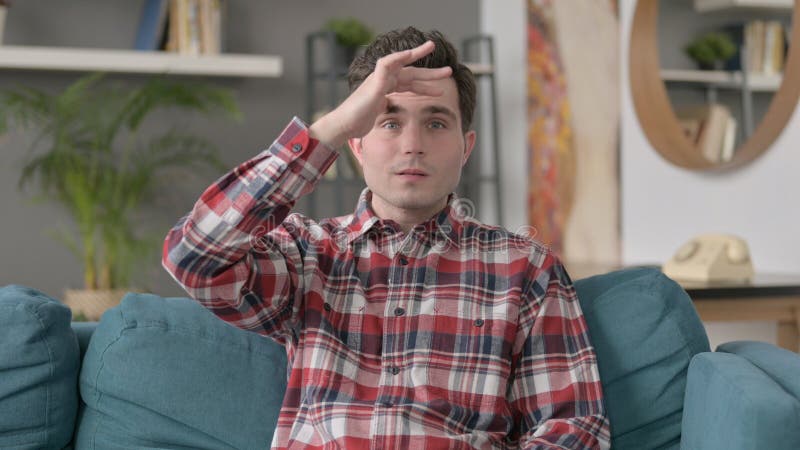 Portrait of Man Looking Around while Sitting on Sofa Stock Photo ...
