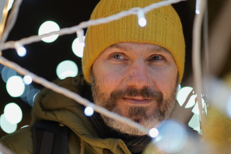 Portrait of Man Looking through the Christmas Lights Stock Photo ...