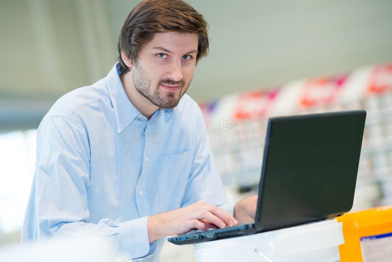 Portrait Man Looking at Laptop in Store Stock Image - Image of consumer ...