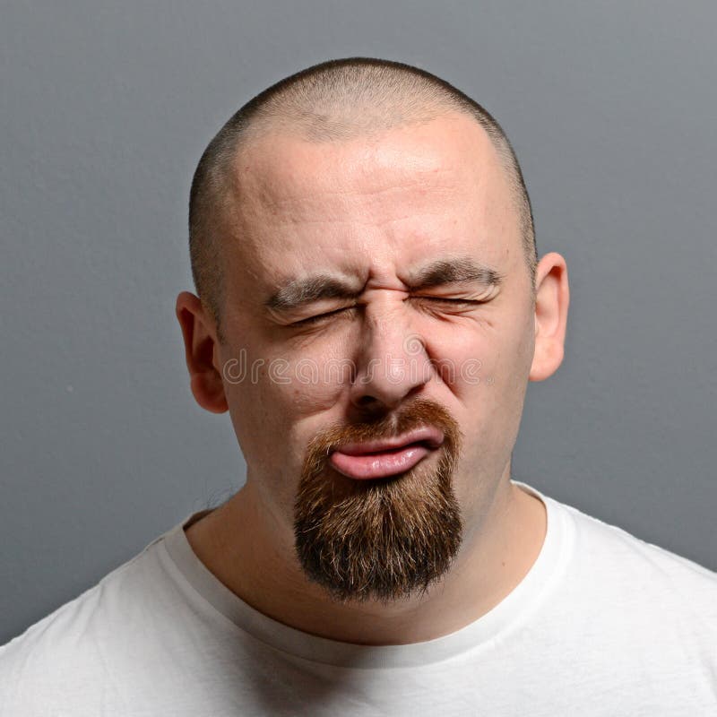 Portrait of a Man Making Funny Face Against Gray Background Stock Photo ...