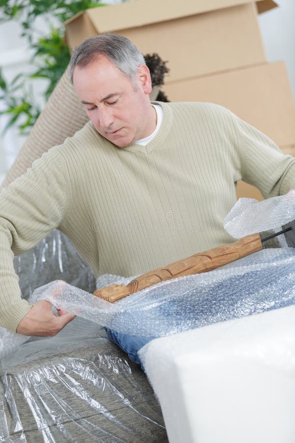 Portrait man packing boxes stock photo. Image of carton - 239477550