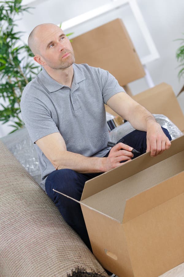 Portrait man packing boxes stock image. Image of move - 196837491