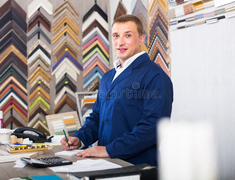 Portrait of Man Seller Working with Picture Frames in Atelier Stock ...