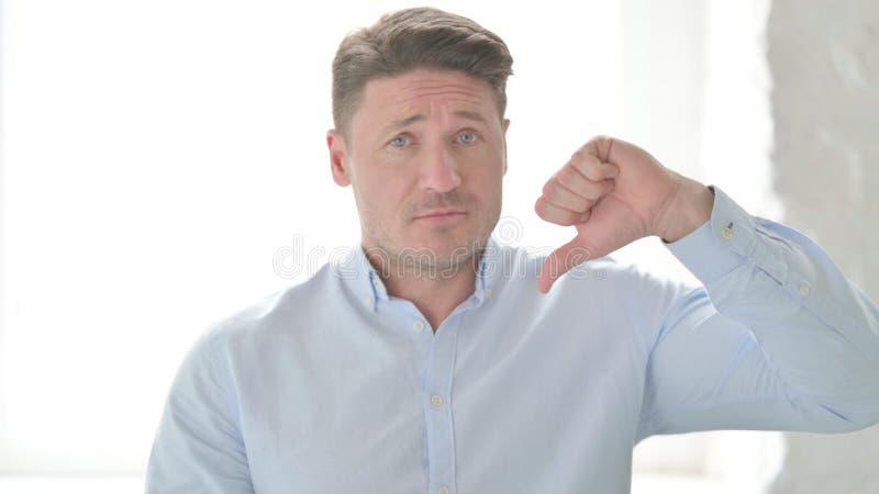 Portrait of Man Showing Thumbs Down Gesture Stock Photo - Image of ...