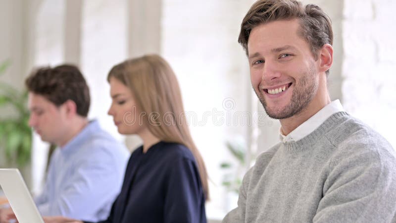 The Portrait of Man and Smiling at the Camera in Office Stock Image ...