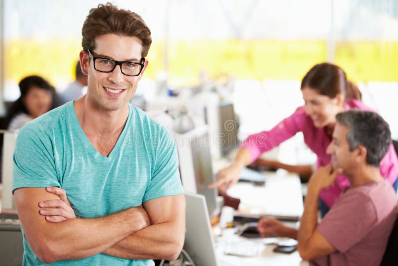 Portrait of Man Standing in Busy Creative Office Stock Photo - Image of ...