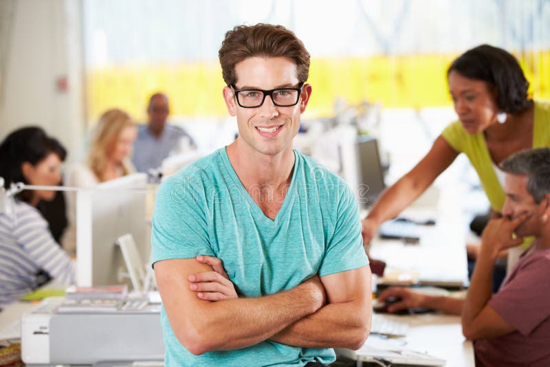 Portrait of Man Standing in Busy Creative Office Stock Photo - Image of ...