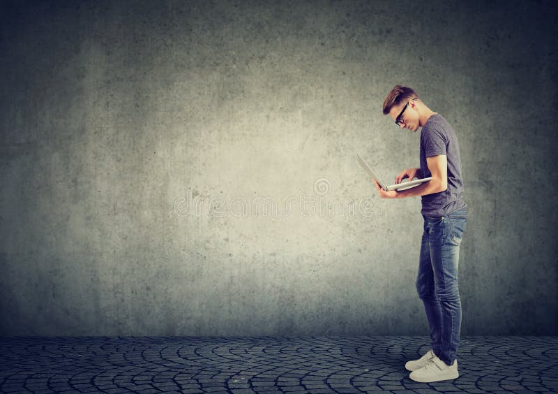 Portrait of a Man Standing Using His Laptop Computer Stock Photo ...