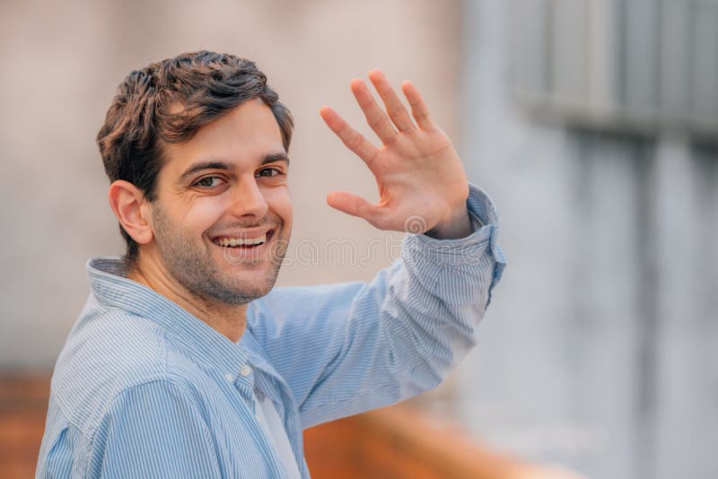 Man in the street waving stock image. Image of gesture - 250841823