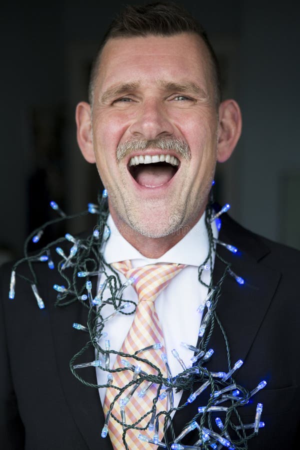Portrait of Man in Suit with String Lights and Laughing Stock Photo ...