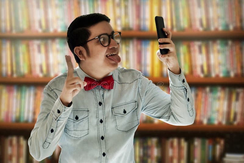 Nerd Man Taking Picture with Mobile Phone Attached To Selfie Stick ...