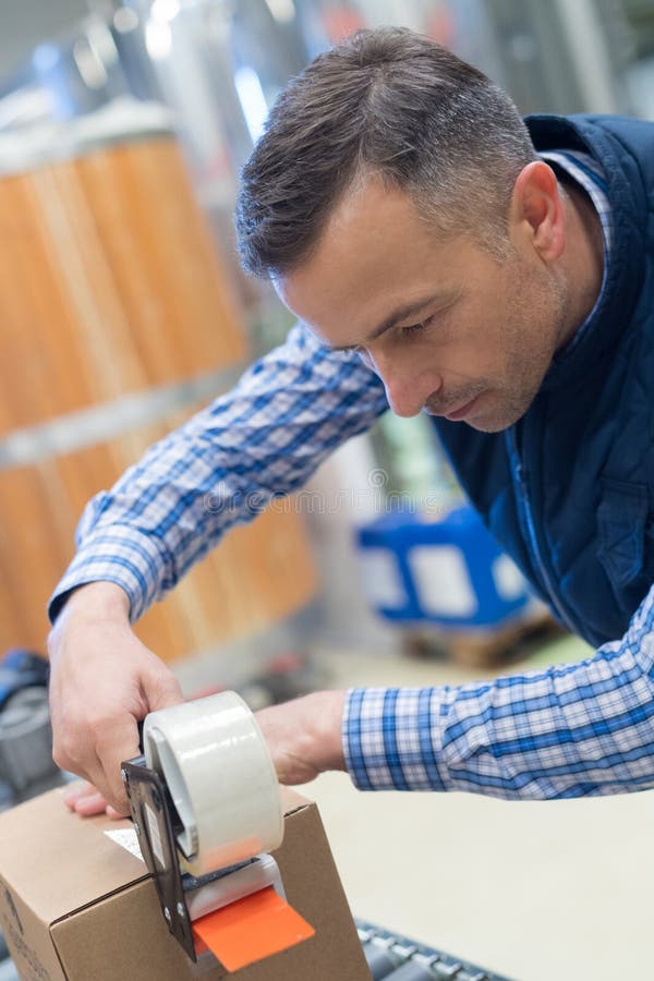 Portrait man taping box stock photo. Image of caucasian - 309078422