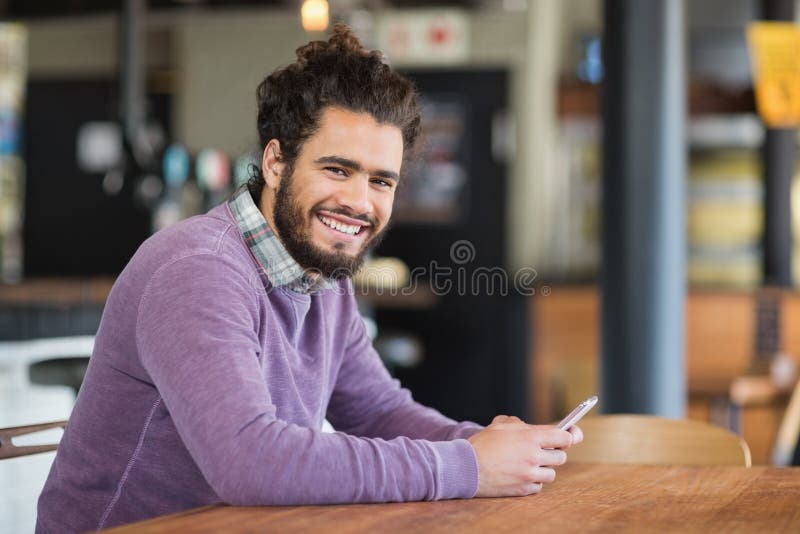 Portrait of Man Using Mobile Phones while Sitting in Restaurant Stock ...
