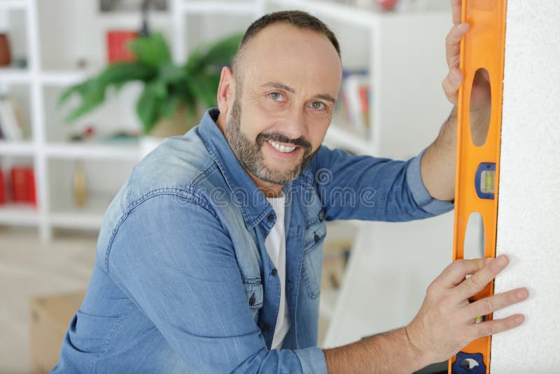 Portrait Man Using Spirit Level in Home Stock Image - Image of ...