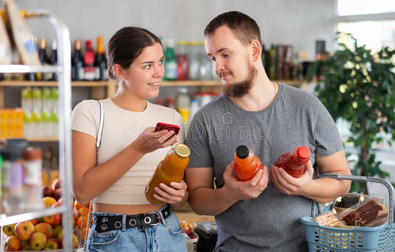 Portrait of Man and Woman Checking the Expiration Date of Juice Using ...