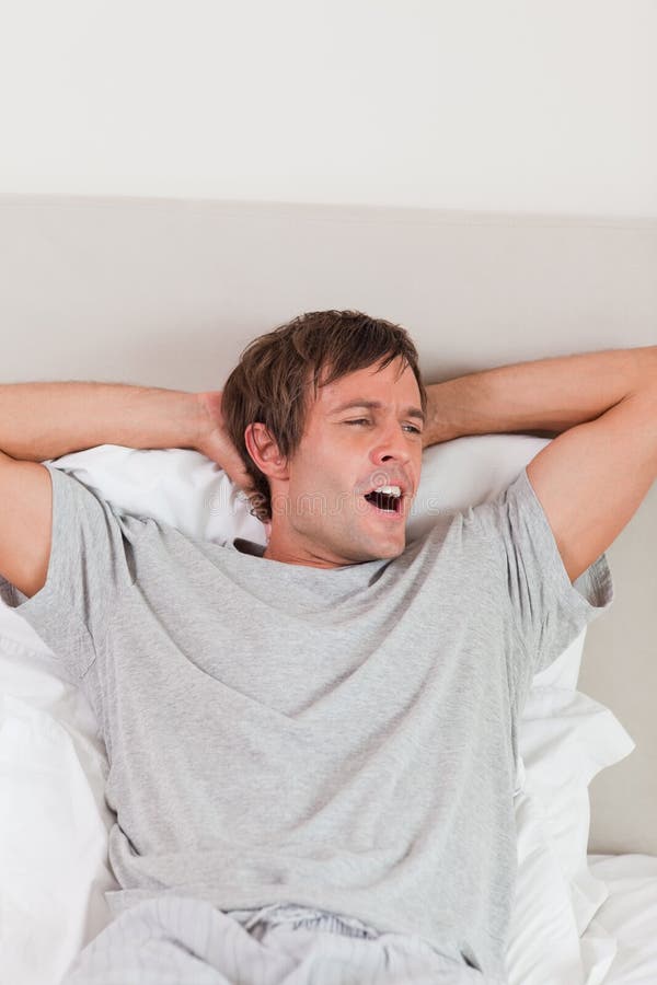 Portrait of a man yawning stock image. Image of pajamas - 22372709