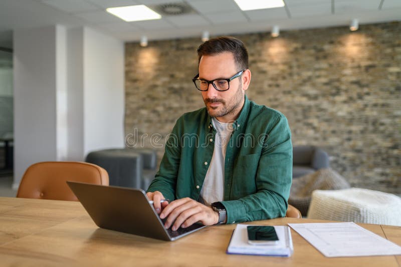 Portrait of Marketing Manager Typing Over Laptop Computer while Working ...
