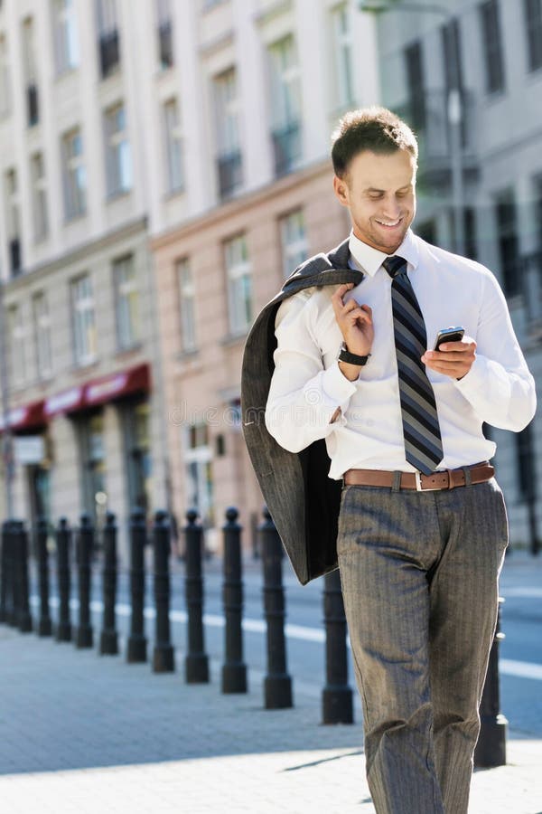 Portrait of Mature Businessman Using Smartphone while Walking on ...