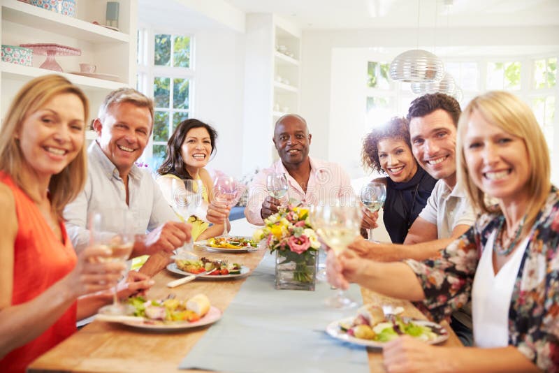 Portrait of Mature Friends Around Table at Dinner Party Stock Photo ...