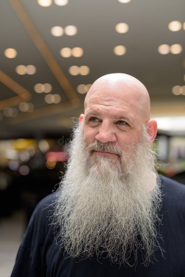 Face of Mature Handsome Bald Bearded Man Thinking in the City Outdoors ... Face of Mature Handsome Bald Bearded Man Thinking in the City Outdoors ...