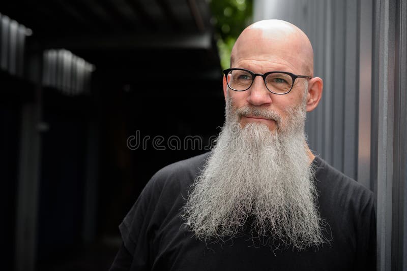 Mature Handsome Bald Bearded Man with Eyeglasses Thinking in the ... Mature Handsome Bald Bearded Man with Eyeglasses Thinking in the ...