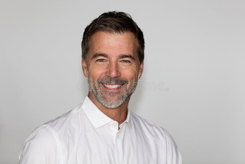 Portrait of a Mature Man Smiling at the Camera. Isolated on White. Left ...