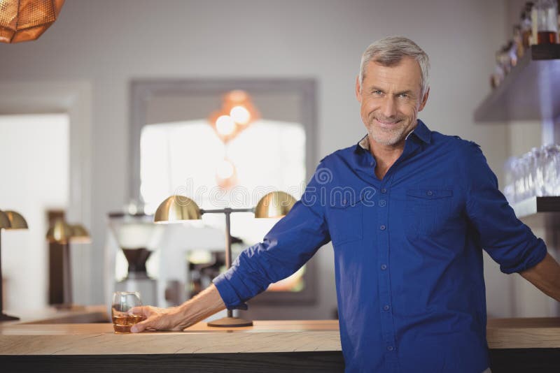 Portrait of Mature Man Standing at Counter Stock Image - Image of ...