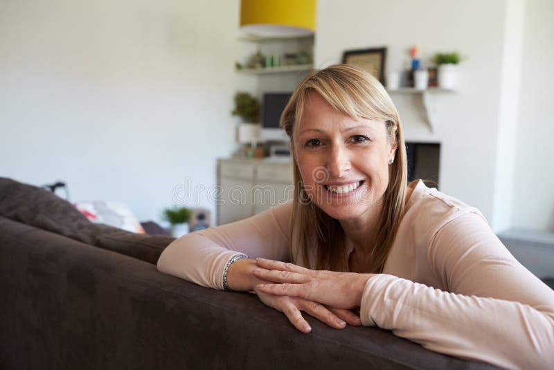 Portrait Of Mature Woman Relaxing On Sofa At Home Stock Image Image