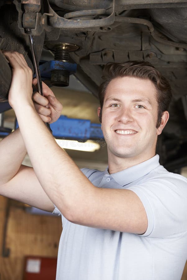 Portrait of Mechanic Working on Wheel Underneath Car Stock Photo ...