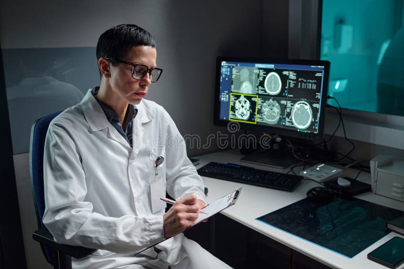 Portrait of Medical Professional Examining Patient Notes Stock Photo ...