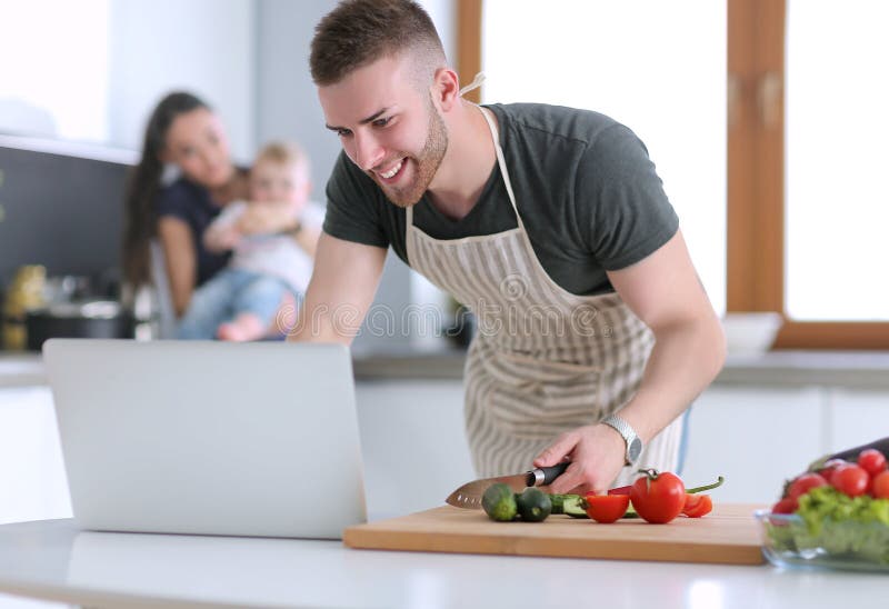 Portrait of Man Cooking Vegetable in the Kitchen while Looking at a ...