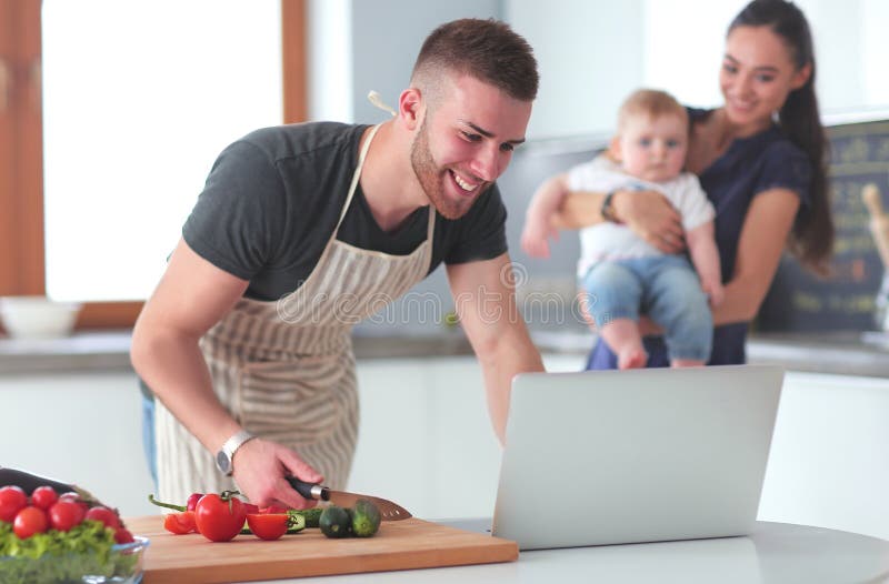 Portrait of Man Cooking Vegetable in the Kitchen while Looking at a ...
